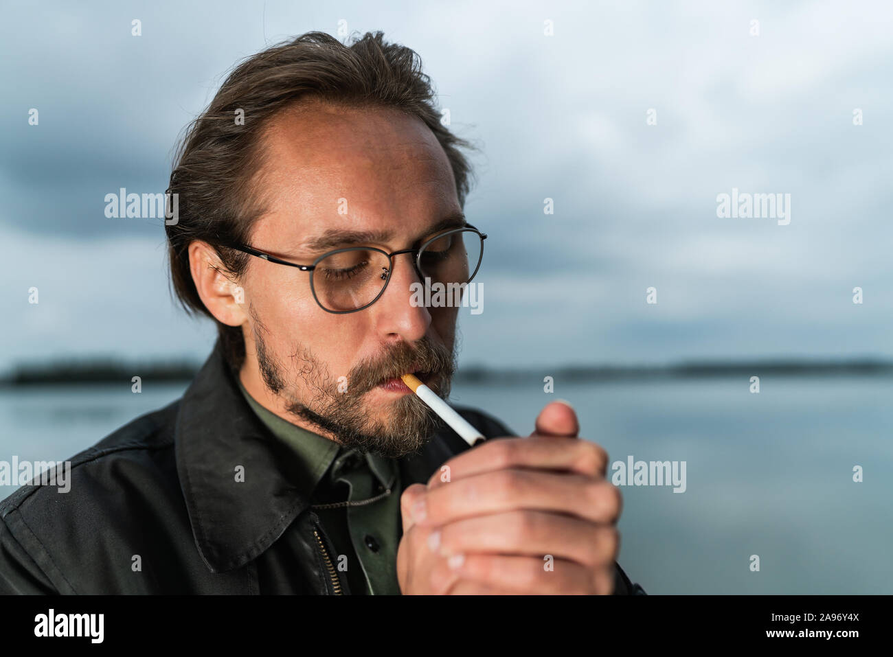 Young man lighting cigar hi-res stock photography and images - Alamy