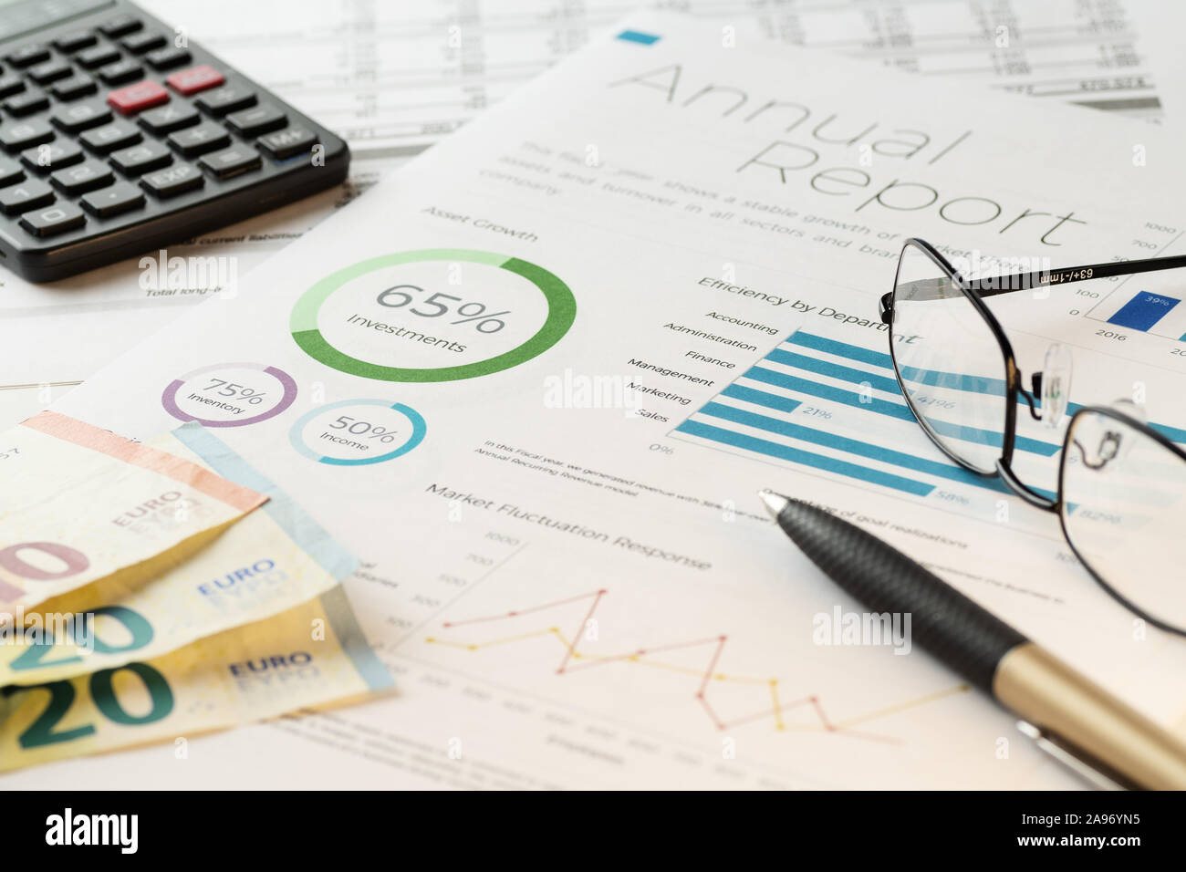 Mockup financial charts report sheet with visible pen, calculator ...