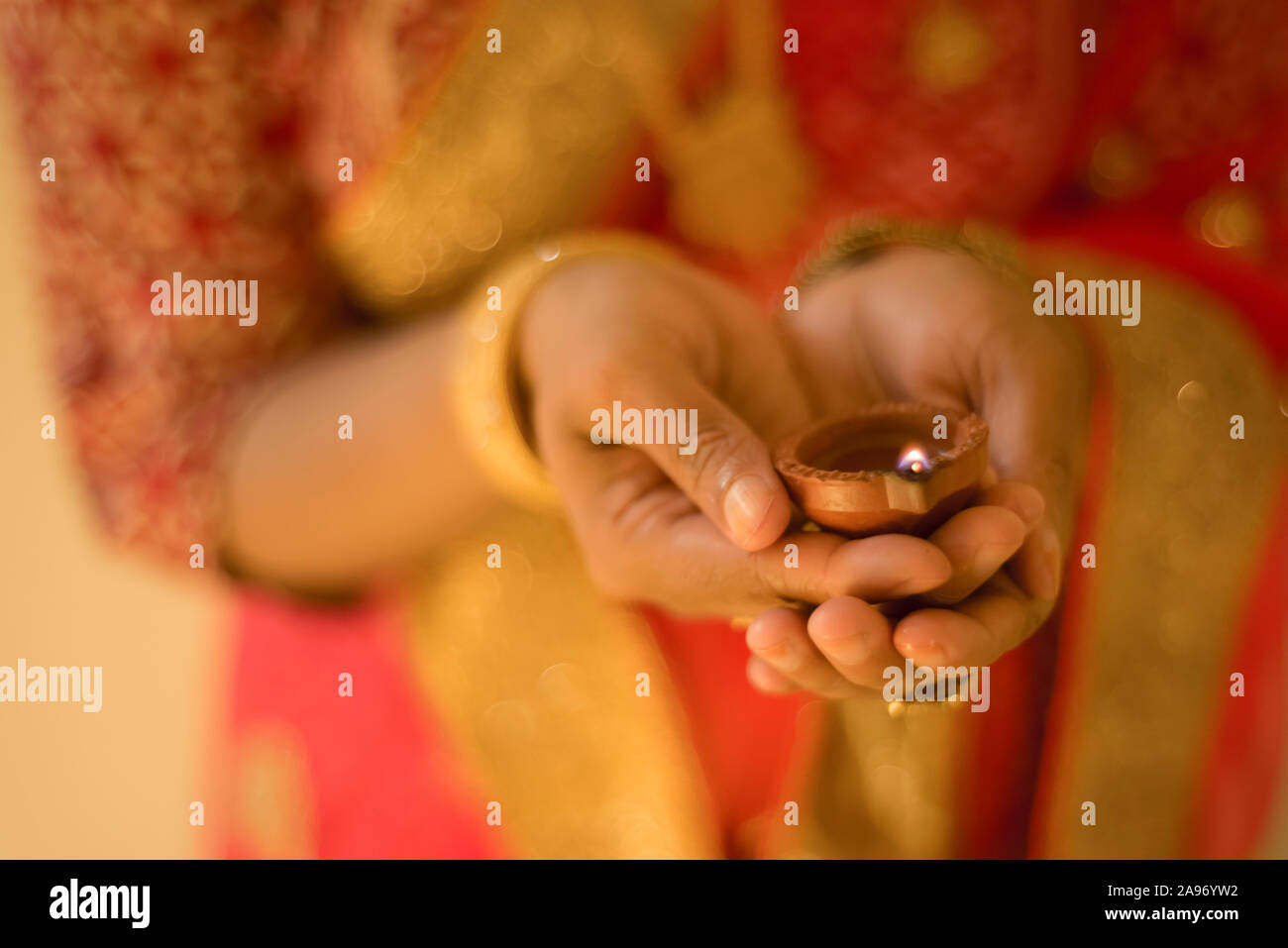 Hand holding diya hi-res stock photography and images - Alamy