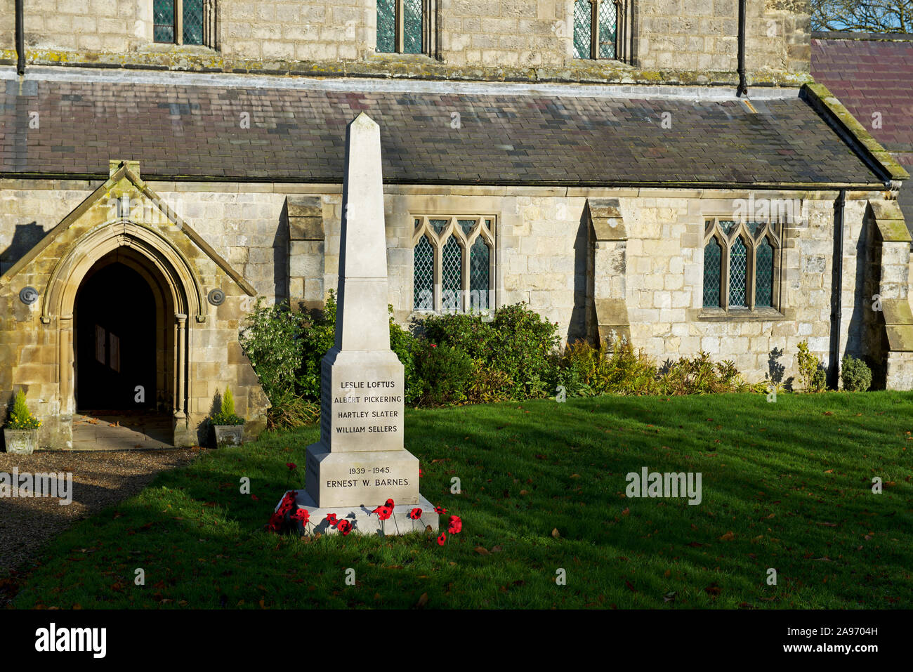 War memorial and St Mary's Church, in the village of Huggate, East ...