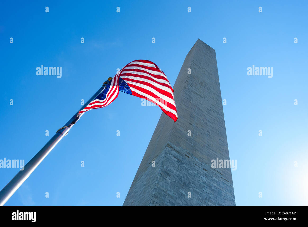 The Washington Monument and an US flag Stock Photo - Alamy