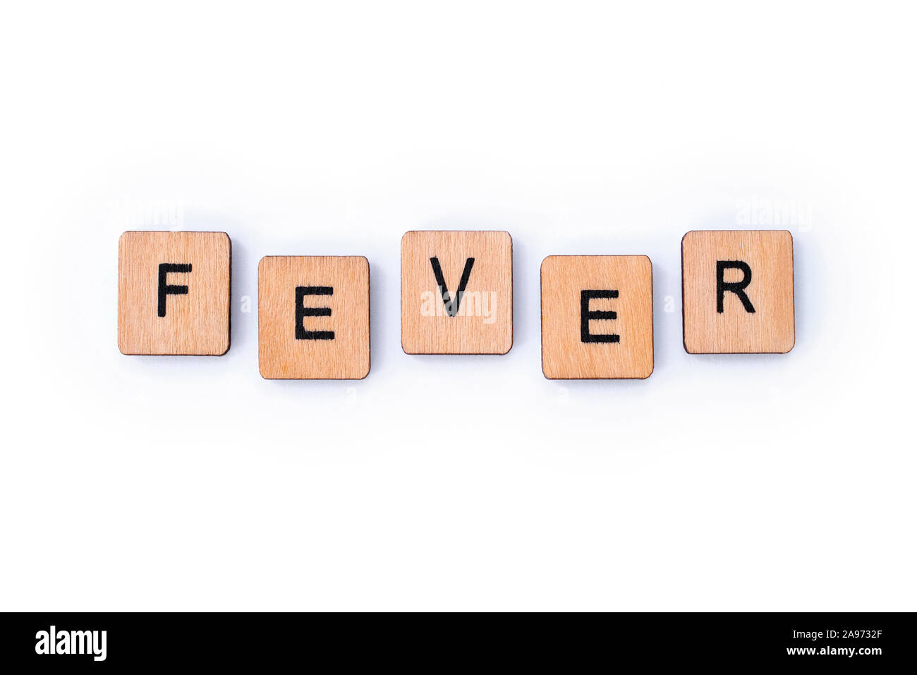 The word FEVER, spelt with wooden letter tiles over a white background ...