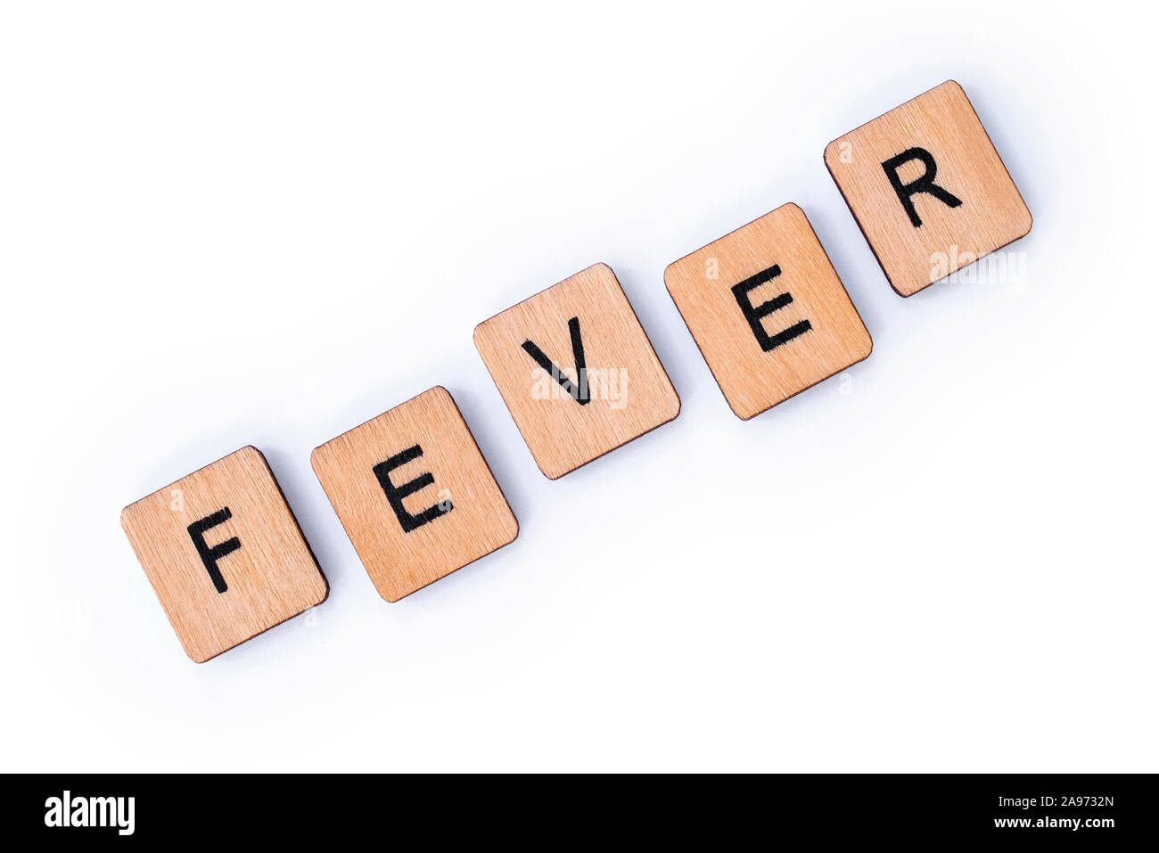 The word FEVER, spelt with wooden letter tiles over a white background ...