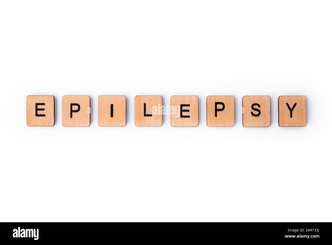 The word EPILEPSY, spelt with wooden letter tiles over a white ...