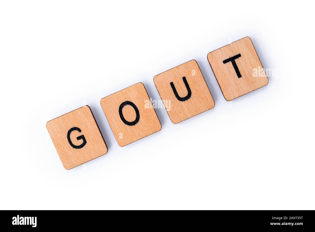 The word GOUT, spelt with wooden letter tiles over a white background ...