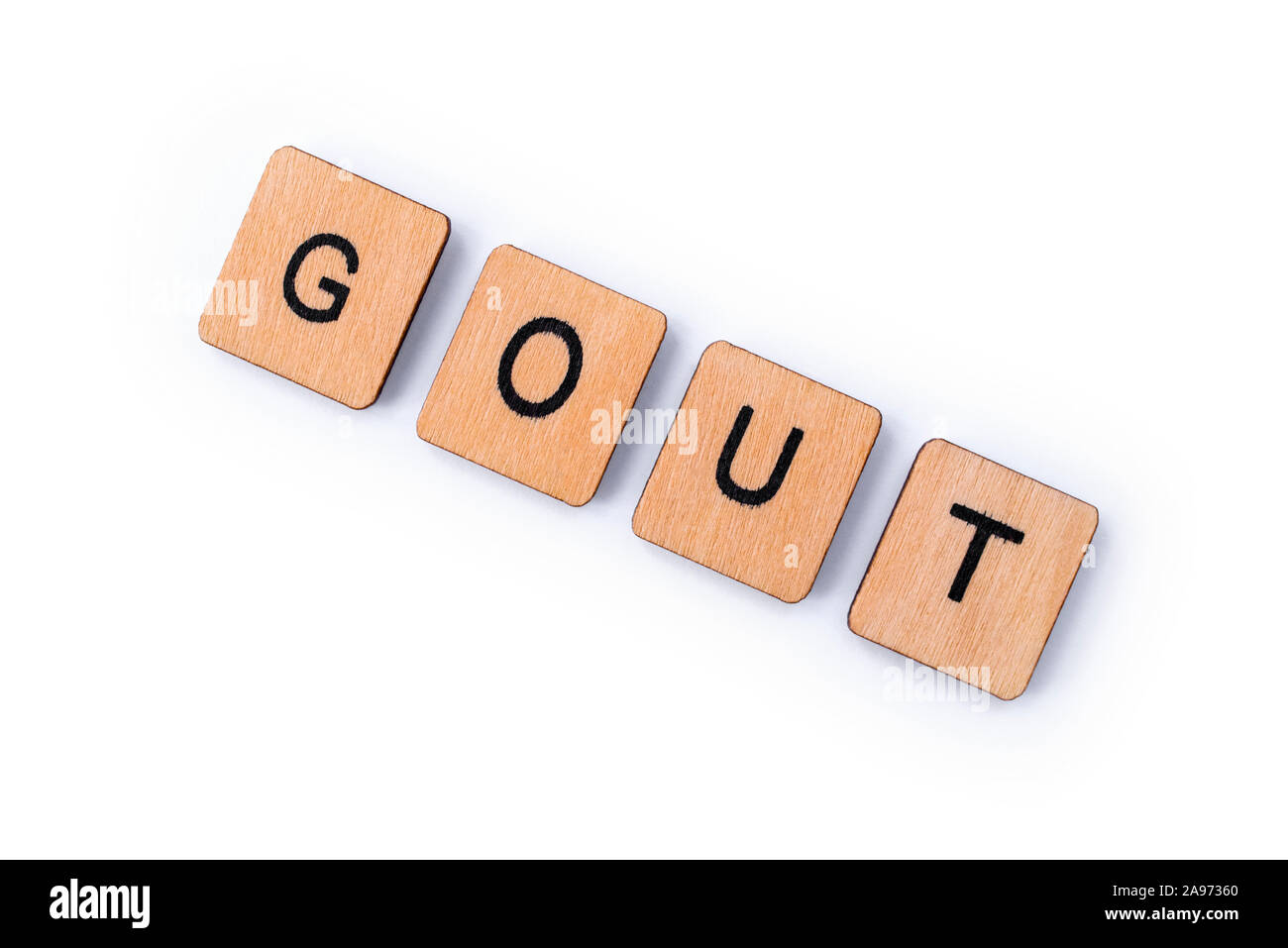 The word GOUT, spelt with wooden letter tiles over a white background ...