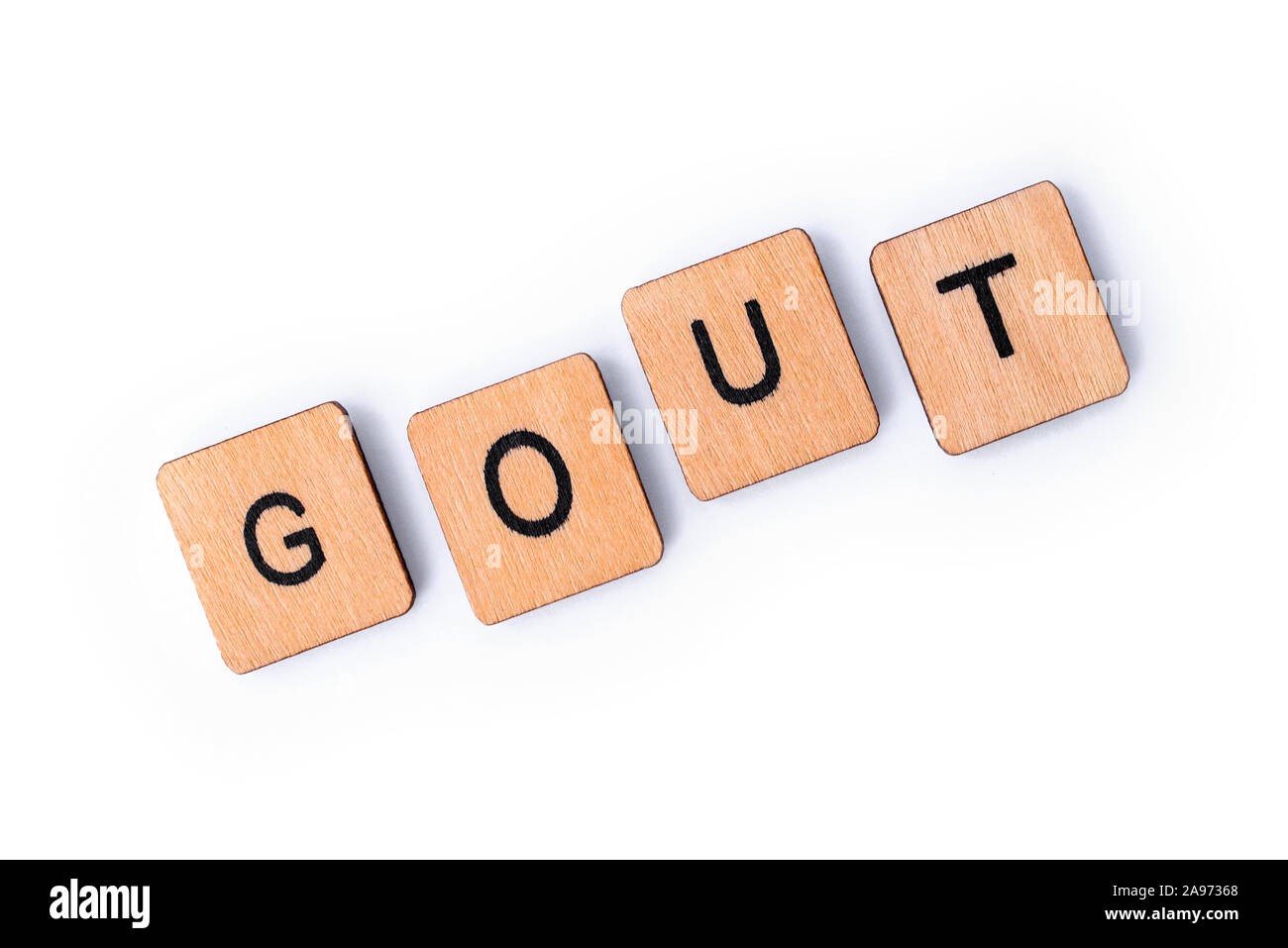 The word GOUT, spelt with wooden letter tiles over a white background ...