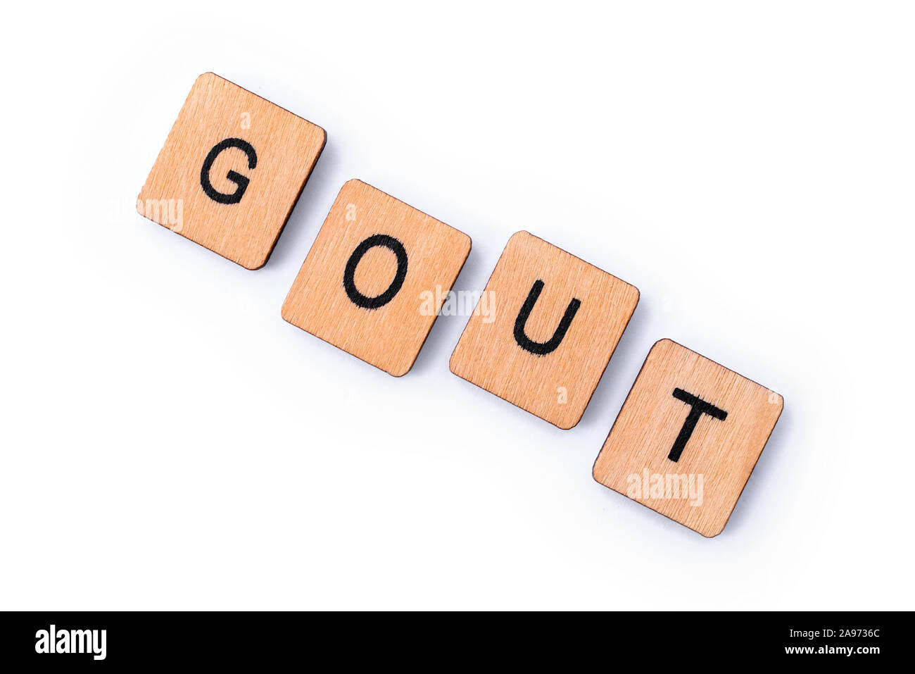The word GOUT, spelt with wooden letter tiles over a white background ...