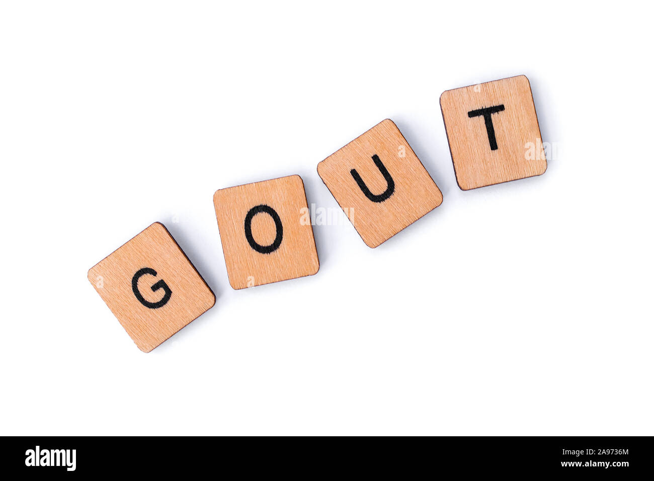 The word GOUT, spelt with wooden letter tiles over a white background ...