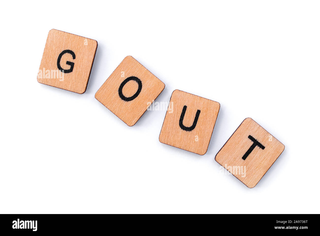 The word GOUT, spelt with wooden letter tiles over a white background ...