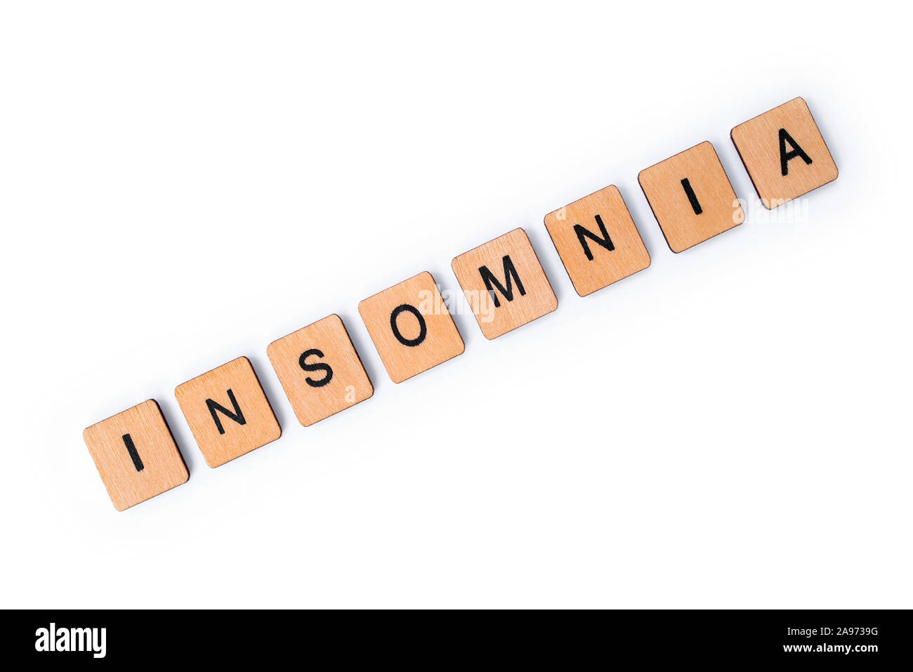 The word INSOMNIA, spelt with wooden letter tiles over a white ...