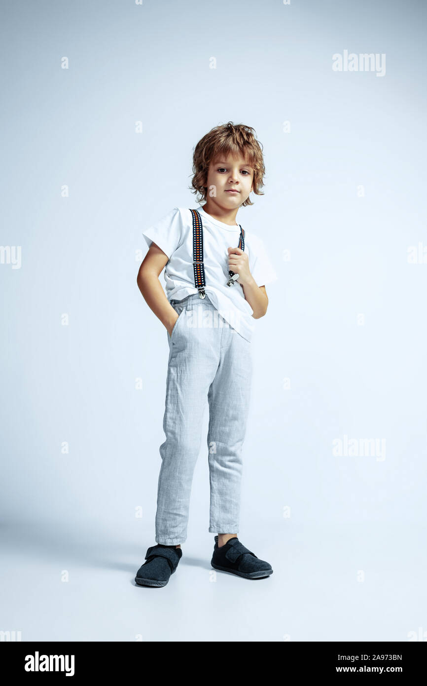 Pretty young boy in casual clothes on white studio background ...