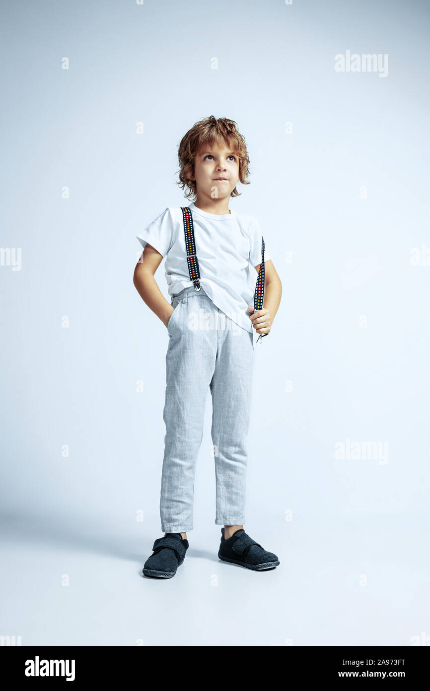 Pretty young boy in casual clothes on white studio background ...