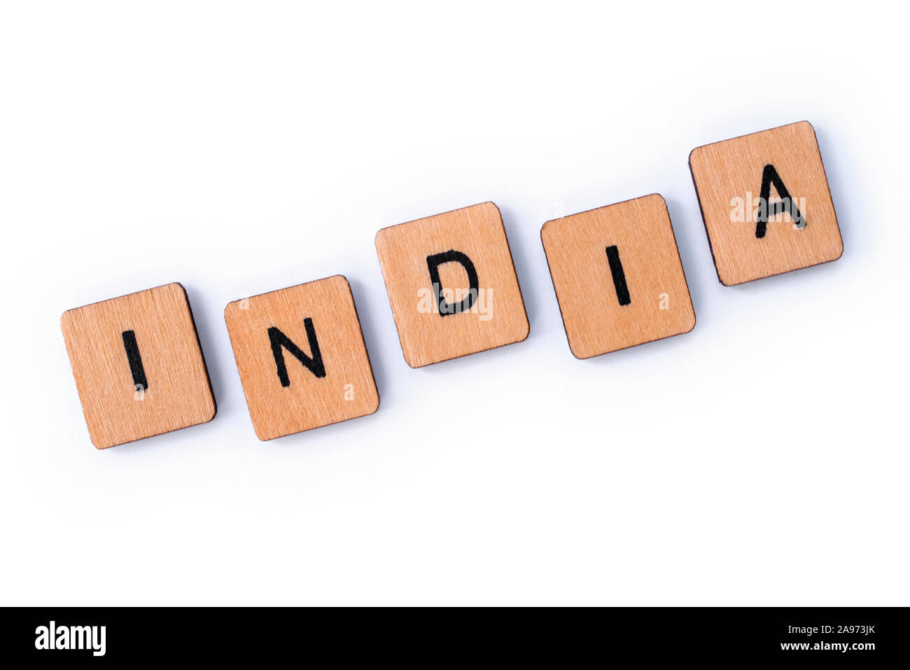 The word INDIA, spelt with wooden letter tiles over a white background ...