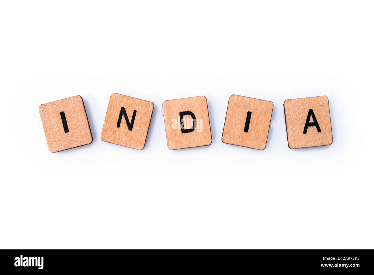 The word INDIA, spelt with wooden letter tiles over a white background ...