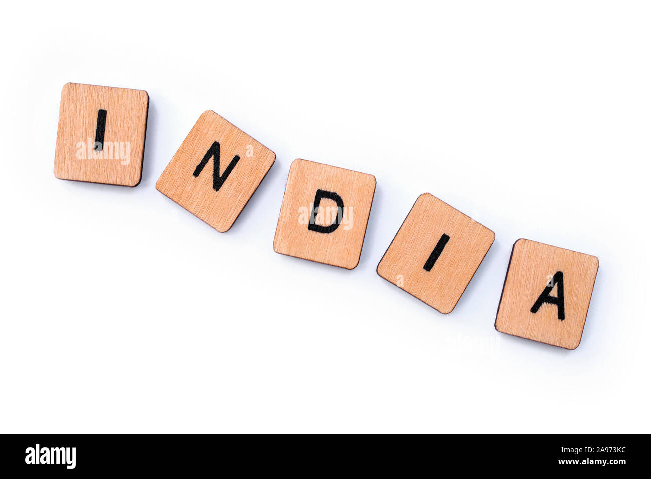The word INDIA, spelt with wooden letter tiles over a white background ...