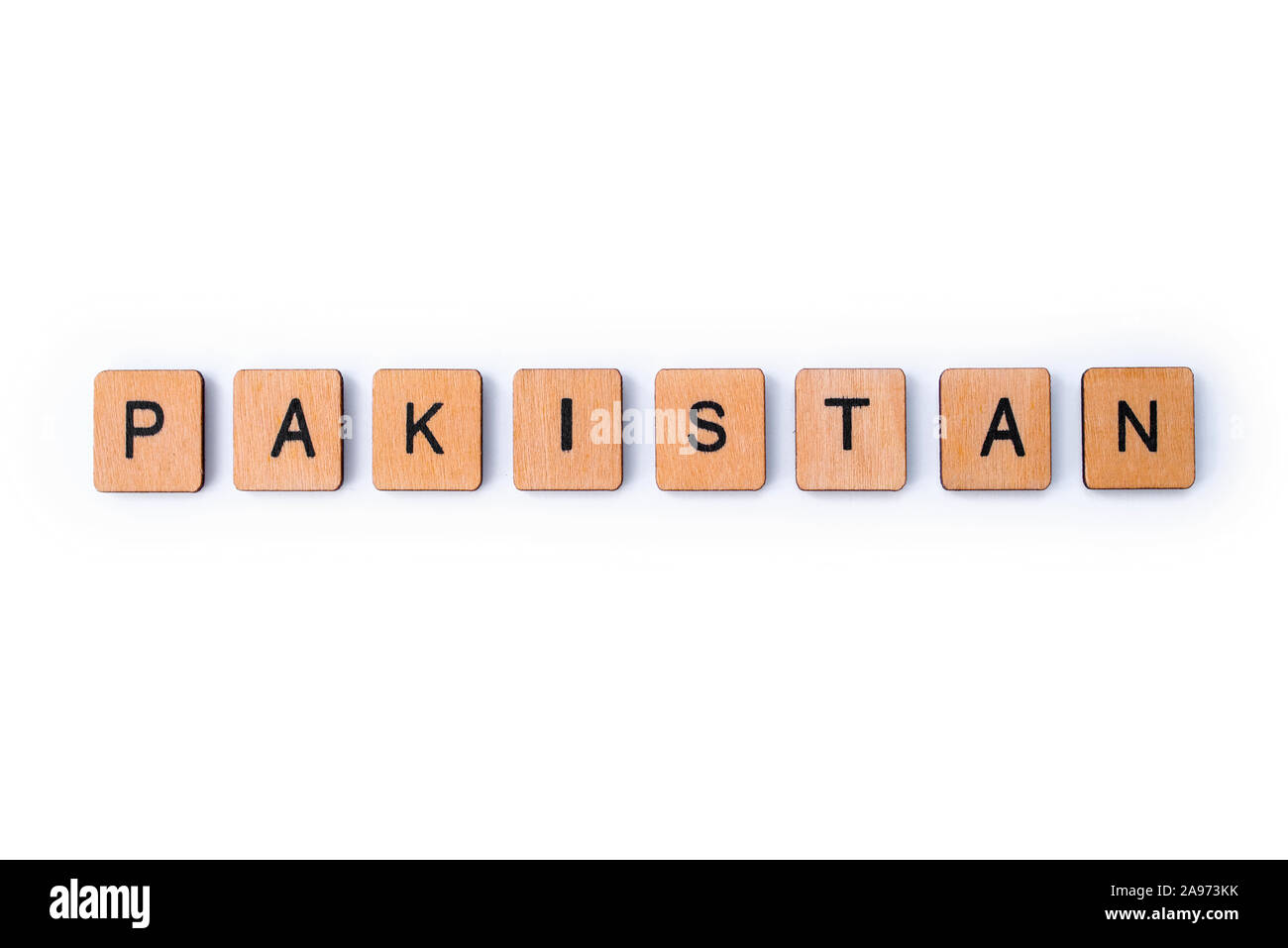 The word PAKISTAN, spelt with wooden letter tiles over a white ...