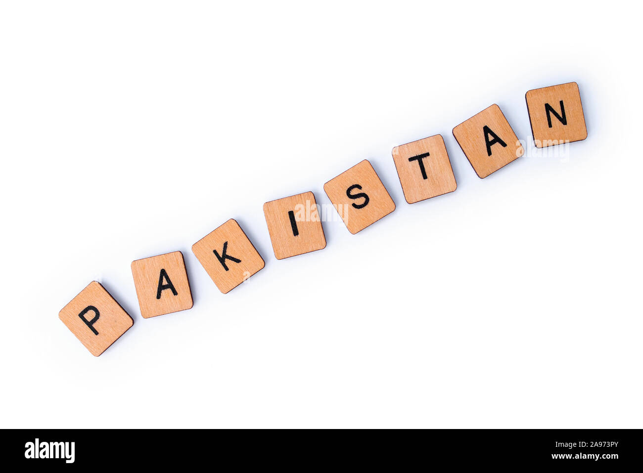 The word PAKISTAN, spelt with wooden letter tiles over a white ...
