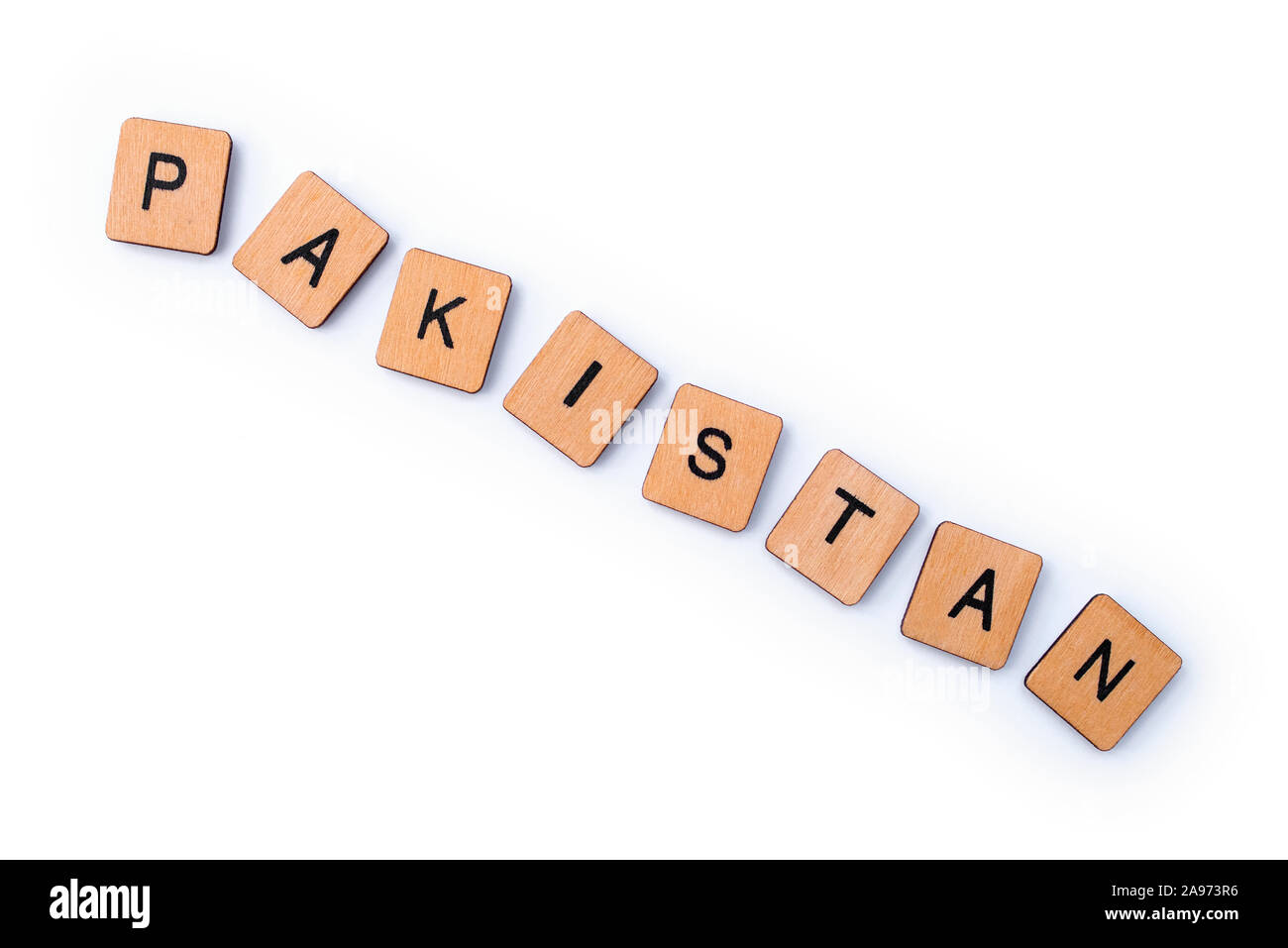 The word PAKISTAN, spelt with wooden letter tiles over a white ...