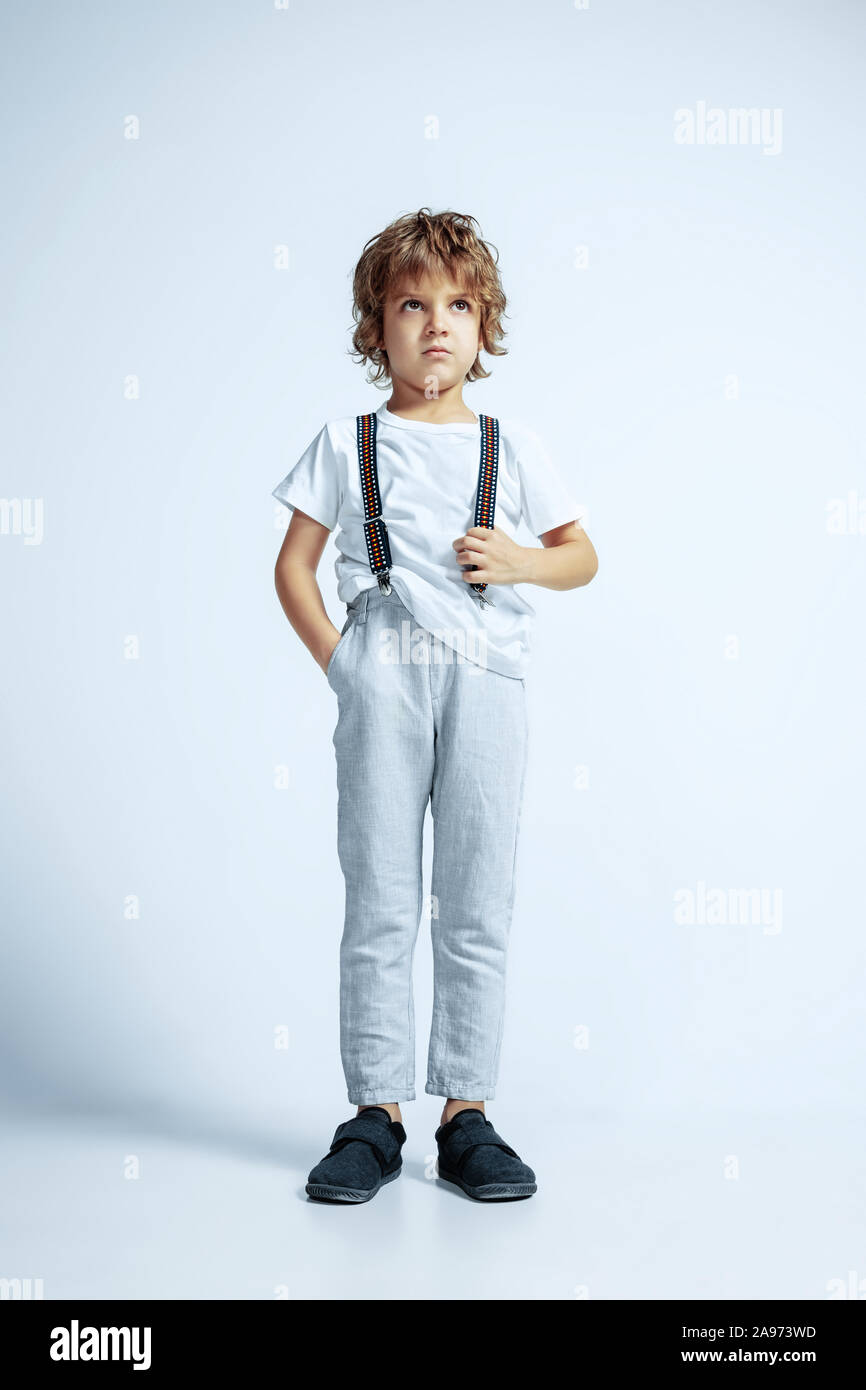 Pretty young boy in casual clothes on white studio background ...