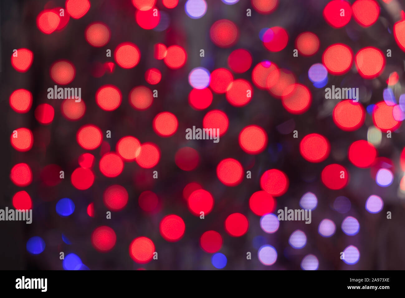 Red blue and purple lights blurred background. Glowing Christmas lights ...