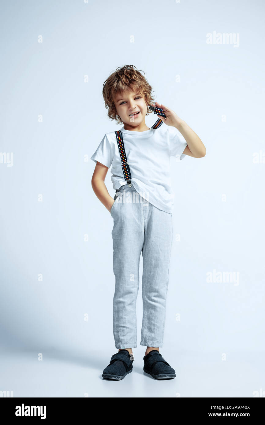 Pretty young boy in casual clothes on white studio background ...