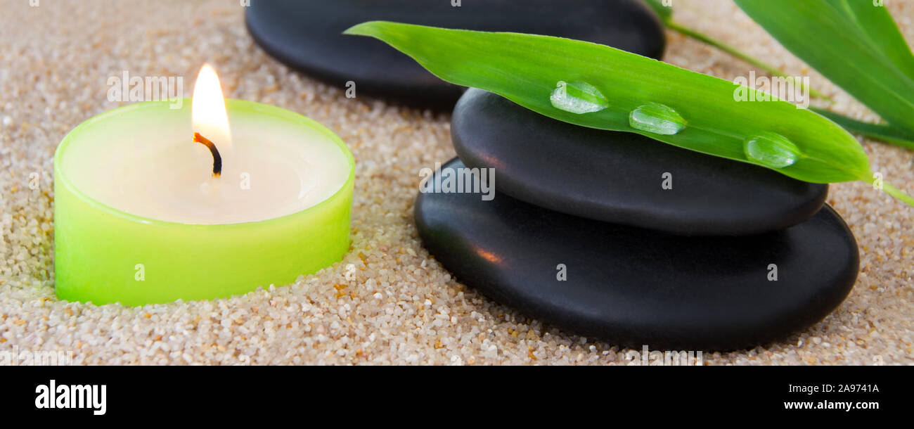 Hot Stones and bamboo with candle Stock Photo - Alamy