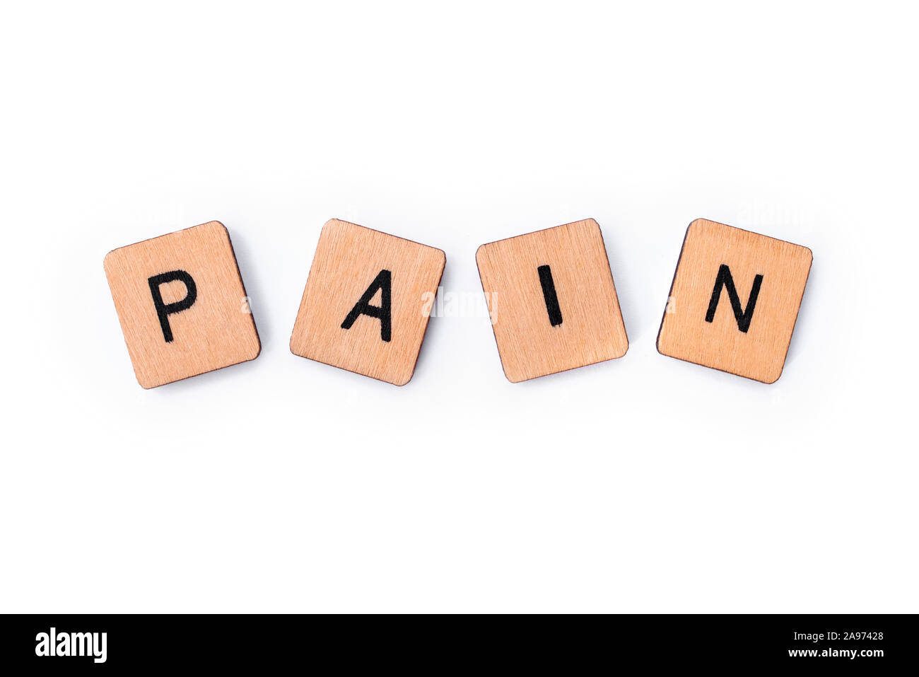 The word PAIN, spelt with wooden letter tiles, over a white background ...