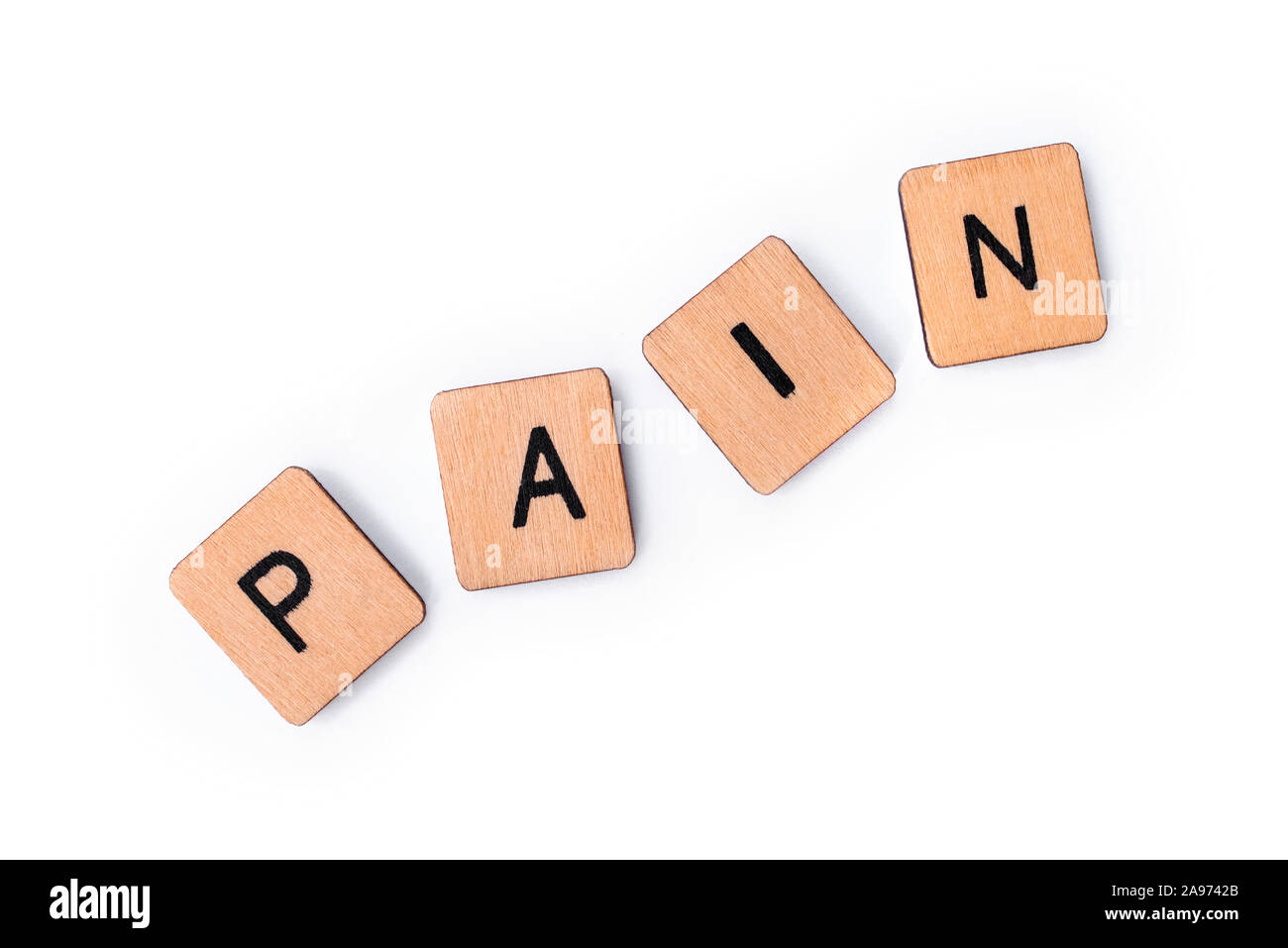 The word PAIN, spelt with wooden letter tiles, over a plain white ...