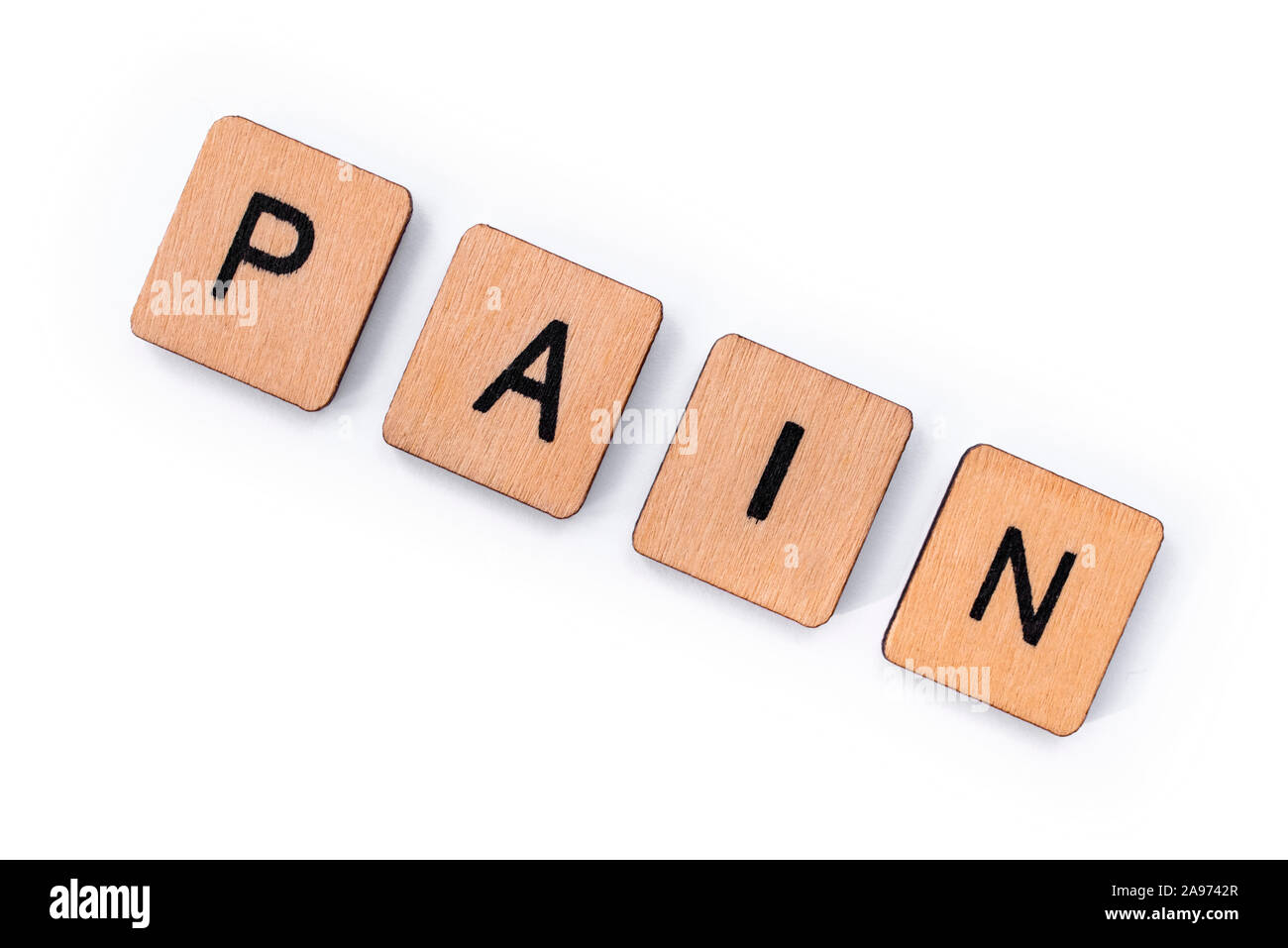 The word PAIN, spelt with wooden letter tiles, over a plain white ...
