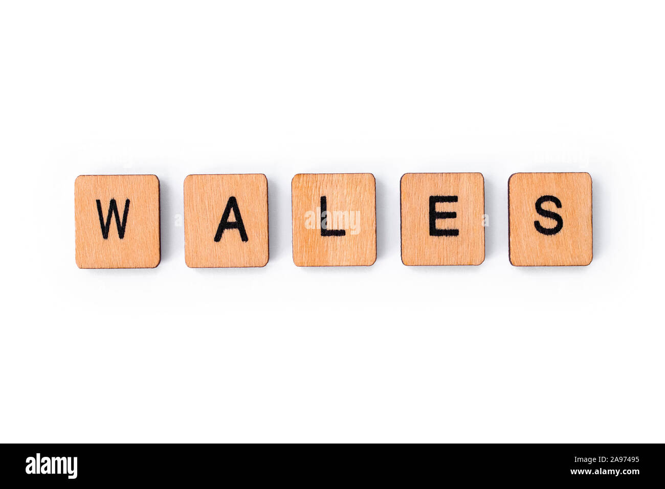 The word WALES, spelt with wooden letter tiles, over a plain white ...