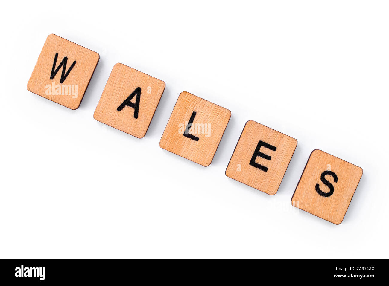 The word WALES, spelt with wooden letter tiles, over a plain white ...