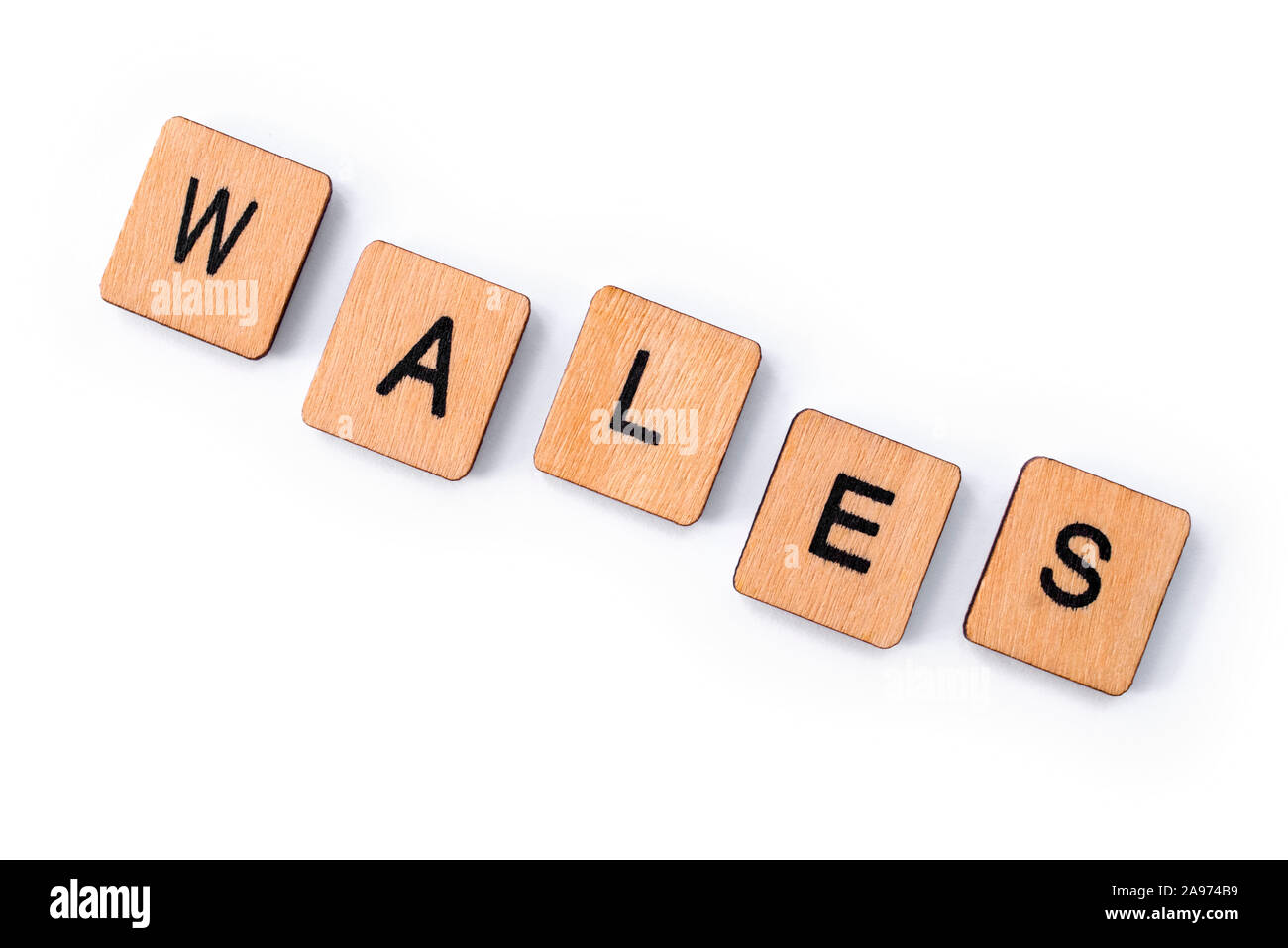 The word WALES, spelt with wooden letter tiles, over a plain white ...