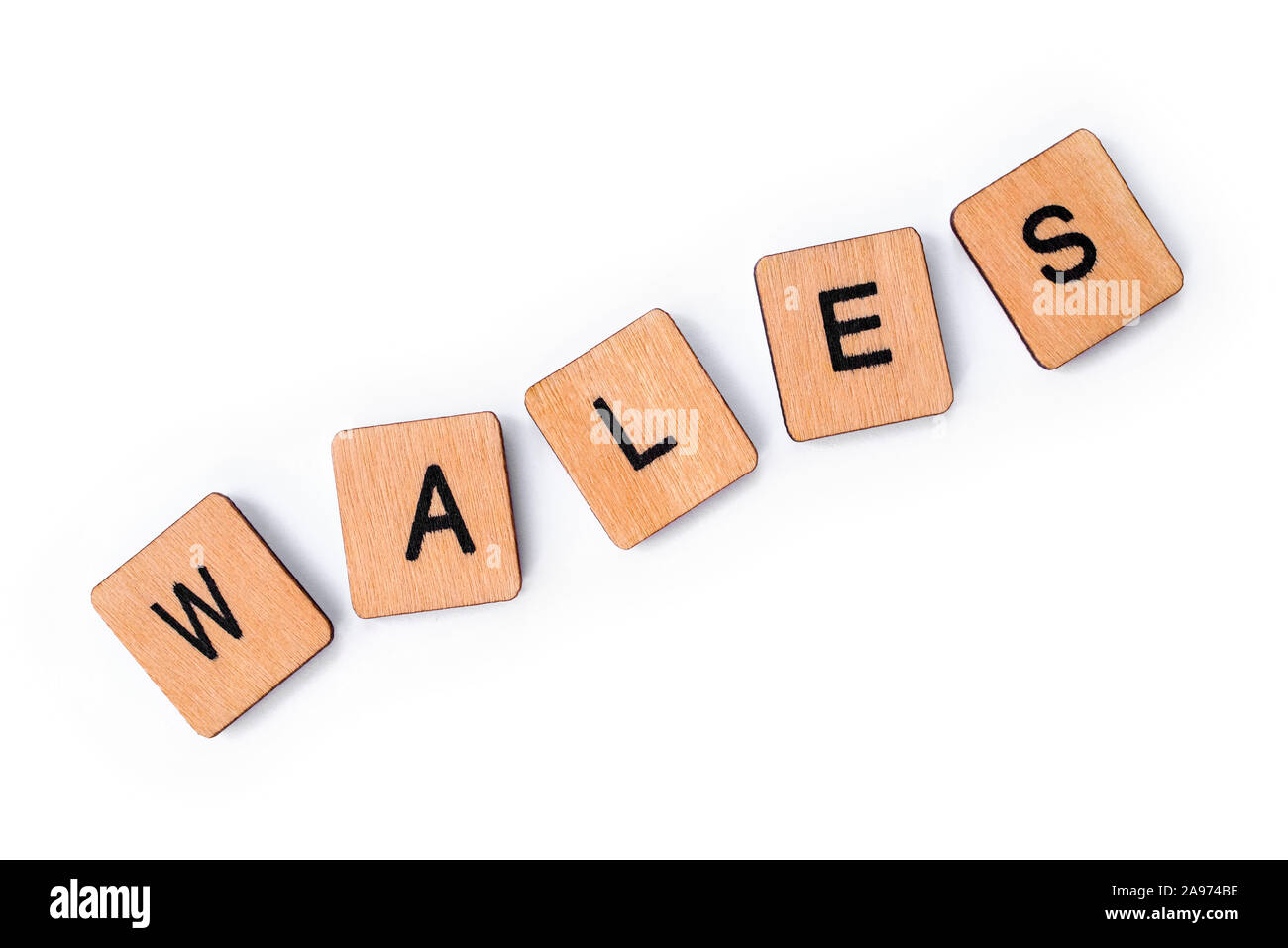 The word WALES, spelt with wooden letter tiles, over a plain white ...