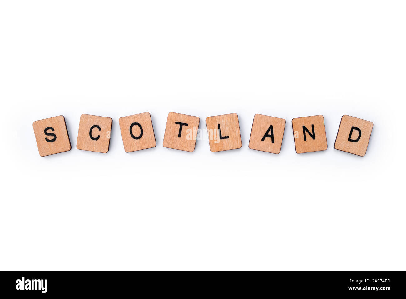 The word SCOTLAND, spelt with wooden letter tiles, over a plain white ...