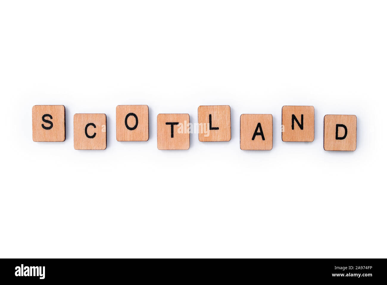 The word SCOTLAND, spelt with wooden letter tiles, over a plain white ...