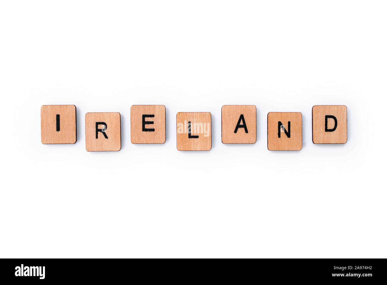 The word IRELAND, spelt with wooden letter tiles, over a plain white ...