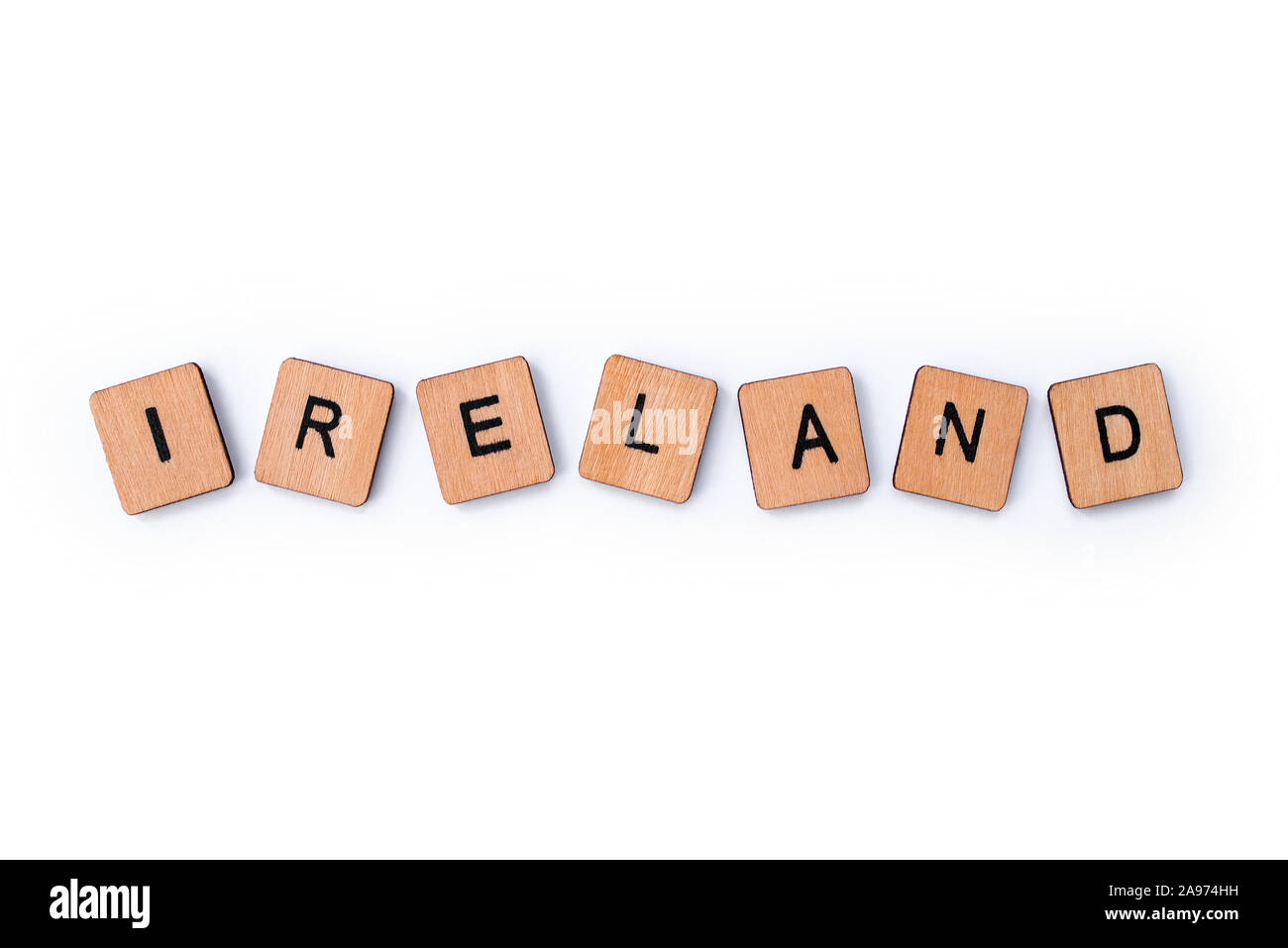 The word IRELAND, spelt with wooden letter tiles, over a plain white ...