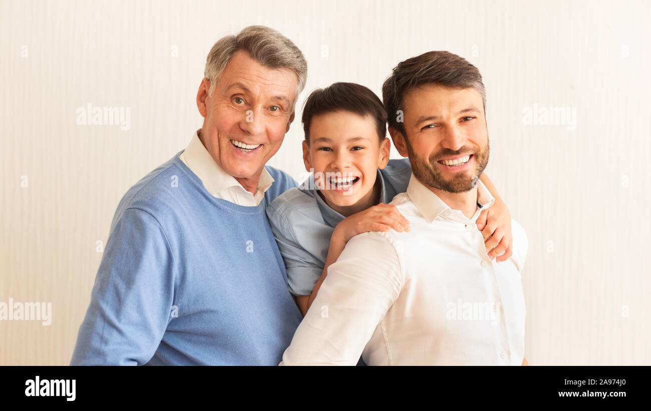 Male Family Portrait. Smiling Boy With Father And Grandfather Hugging ...