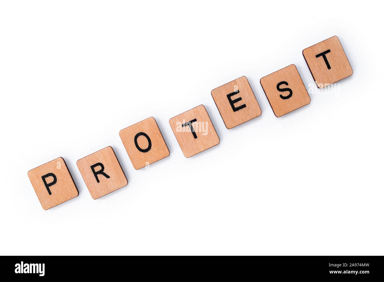 The word PROTEST, spelt with wooden letter tiles over a plain white ...