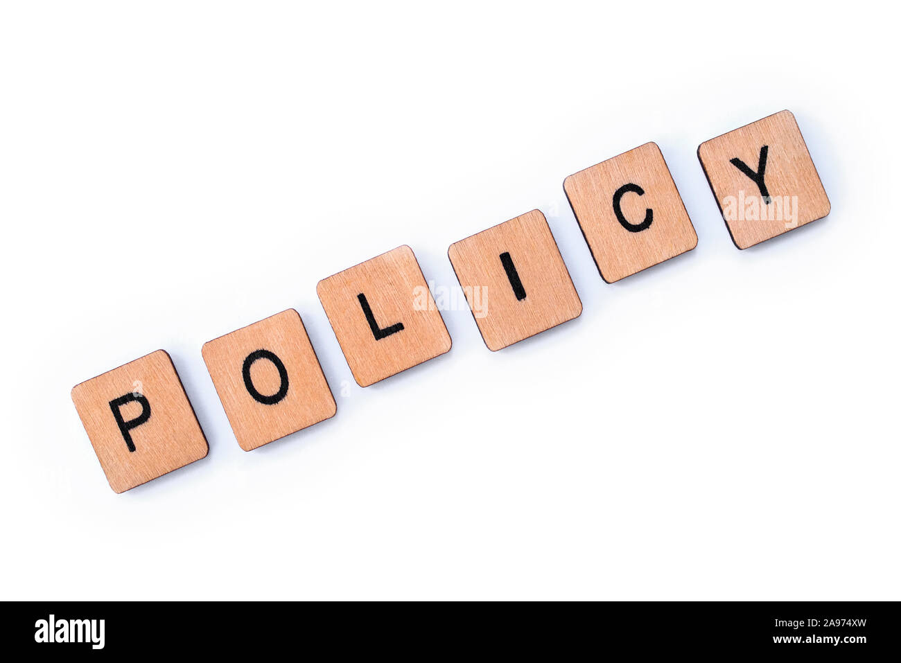 The word POLICY, spelt with wooden letter tiles over a plain white ...