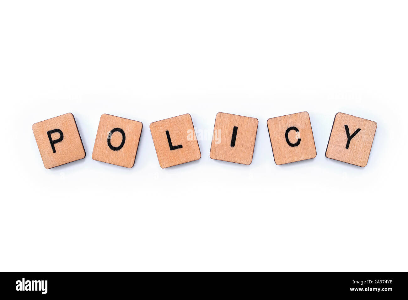 The word POLICY, spelt with wooden letter tiles over a plain white ...