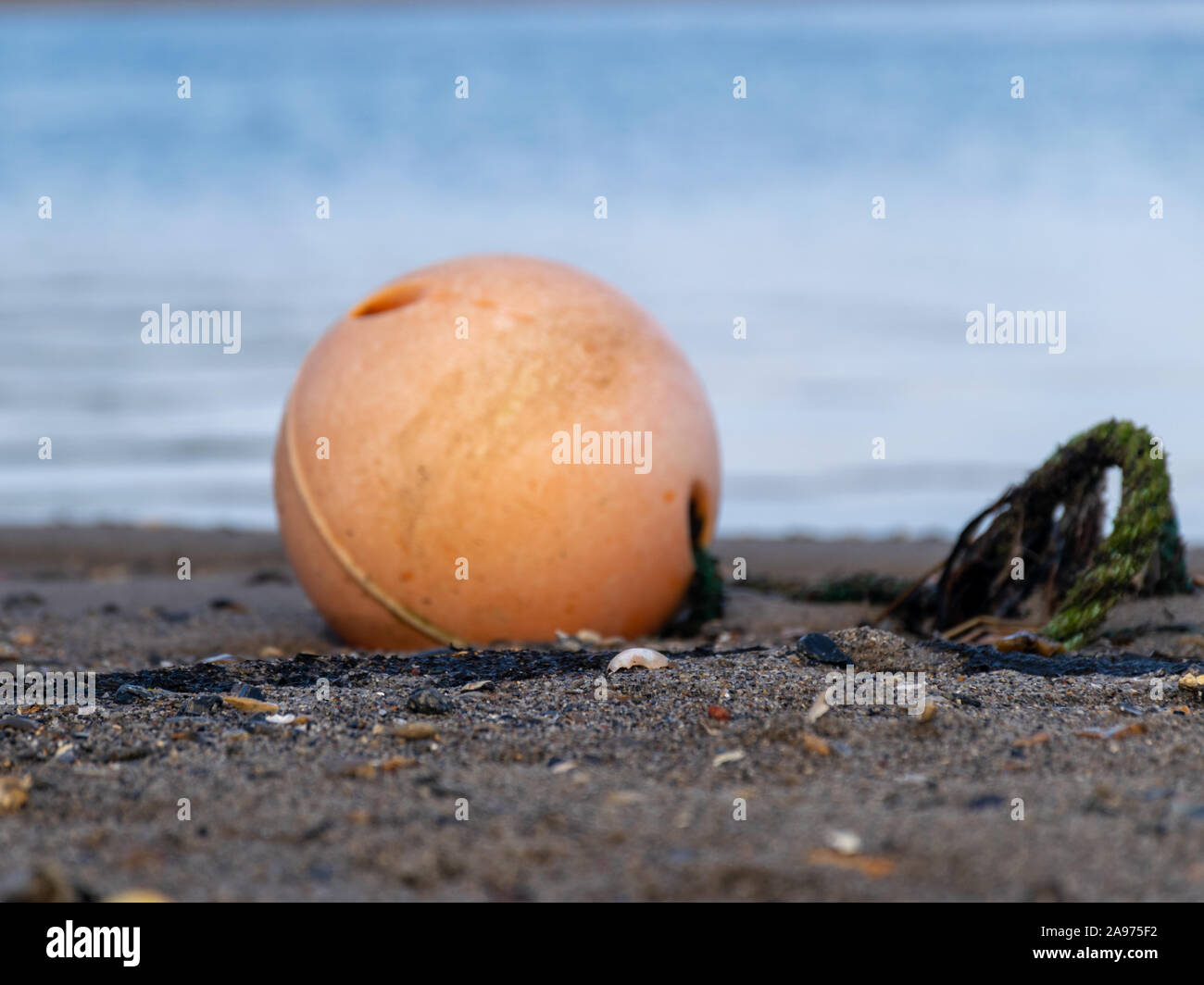 picture with round buoy shore sand Stock Photo - Alamy