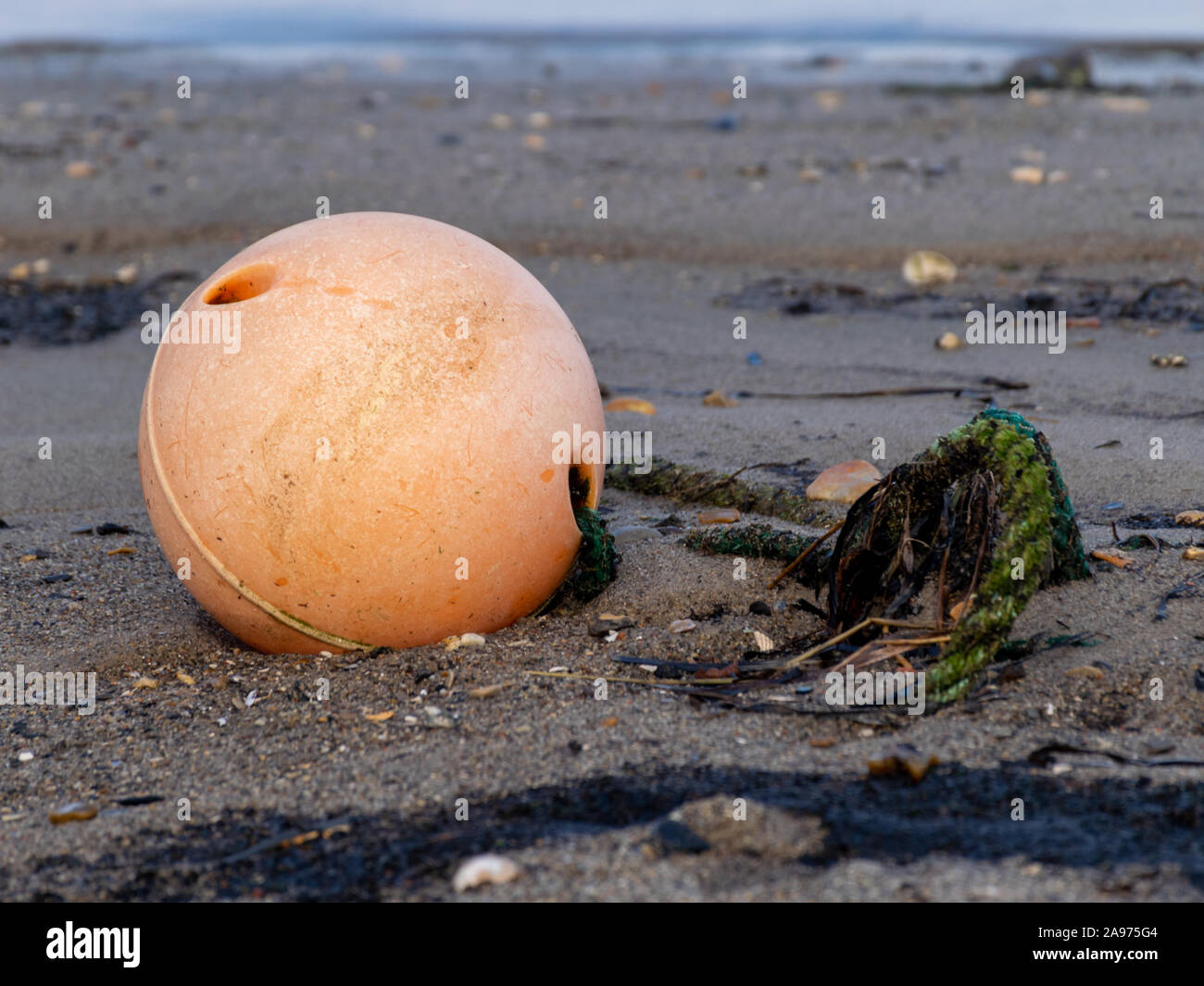 picture with round buoy shore sand Stock Photo - Alamy