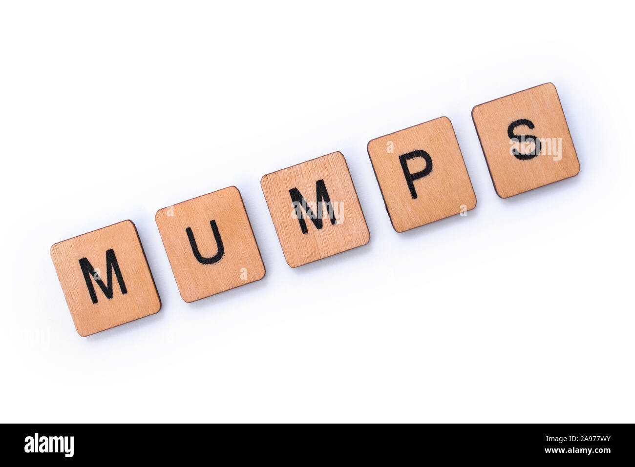 The word MUMPS, spelt with wooden letter tiles over a white background ...