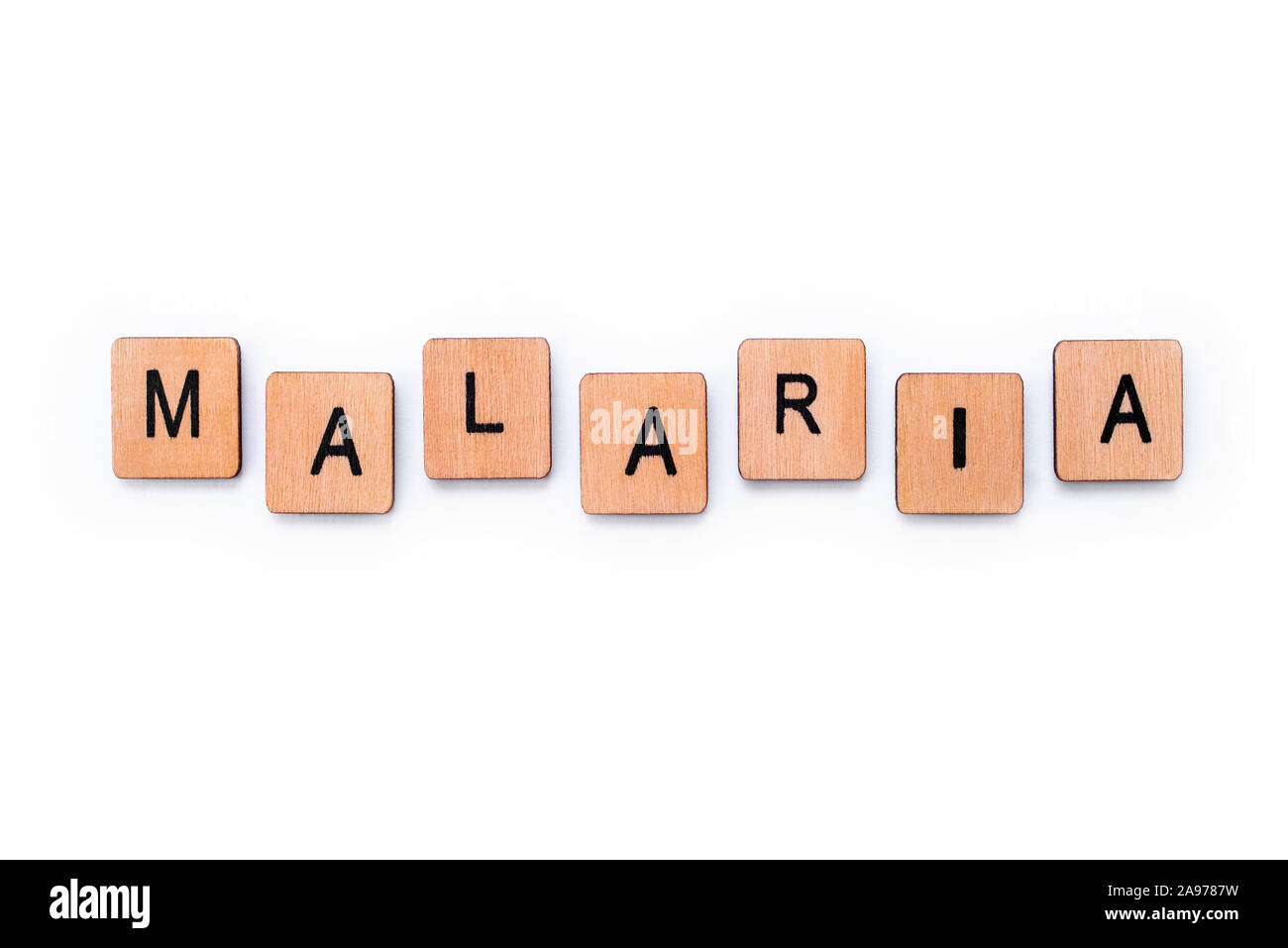 The word MALARIA, spelt with wooden letter tiles over a white ...