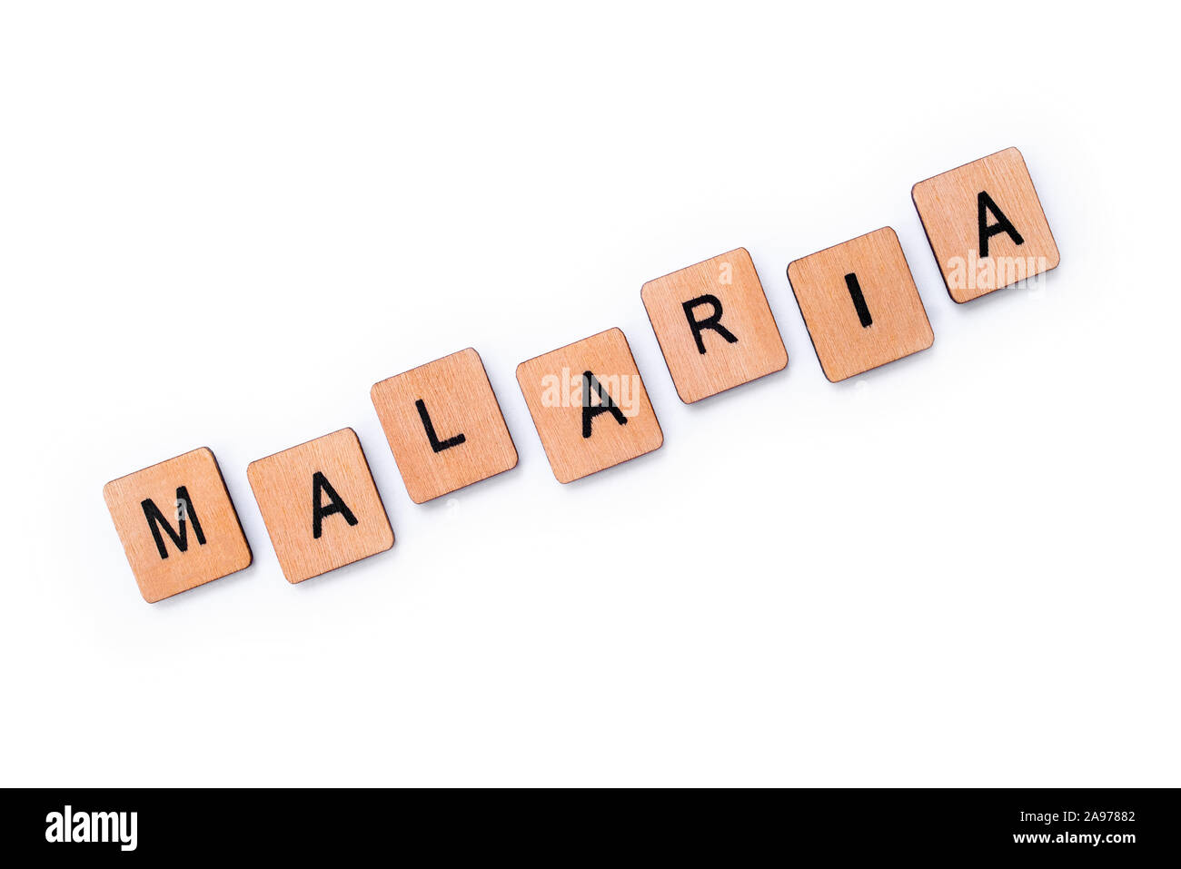 The word MALARIA, spelt with wooden letter tiles over a white ...