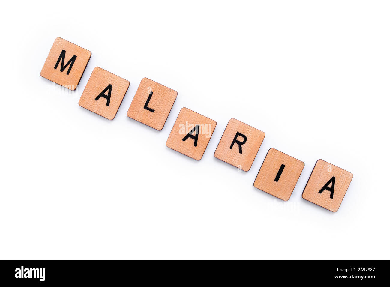 The word MALARIA, spelt with wooden letter tiles over a white ...