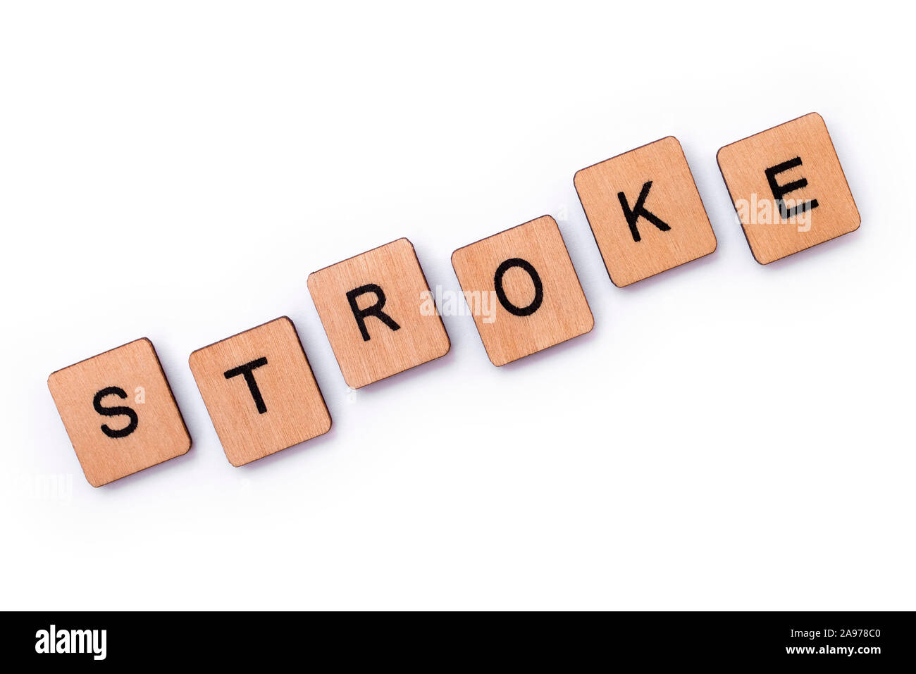 The word STROKE, spelt with wooden letter tiles over a white background ...