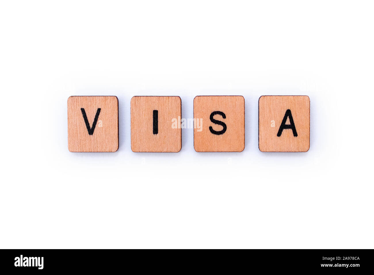 The word VISA, spelt with wooden letter tiles over a white background ...
